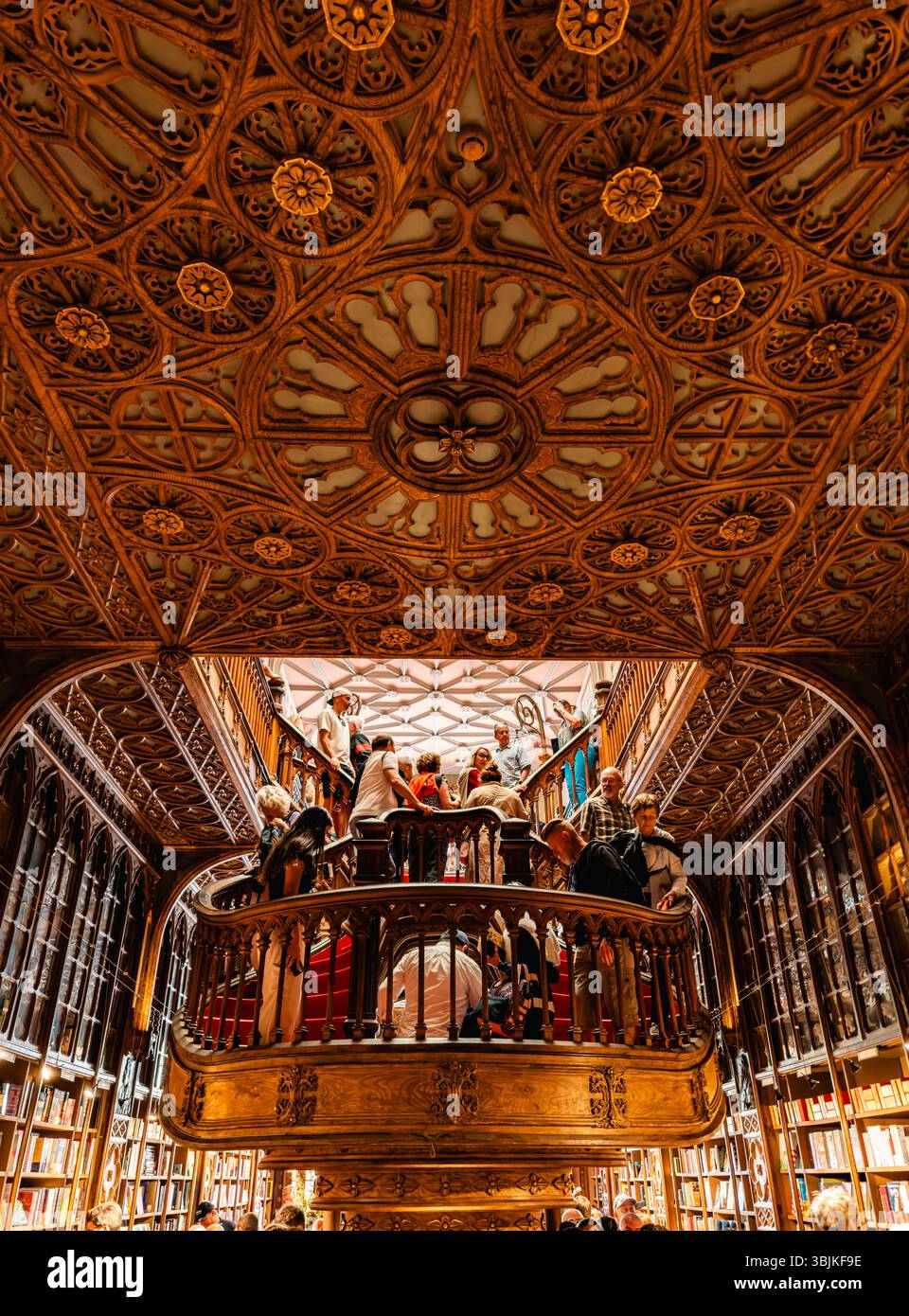 Visitors admire the intricate wooden ceiling and grand staircase inside ...