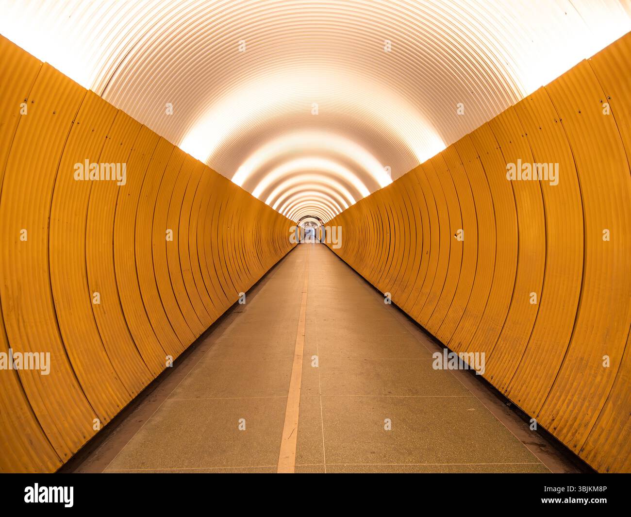 Stockholm, Sweden - May 11th 2025: A long, curving tunnel with smooth ...