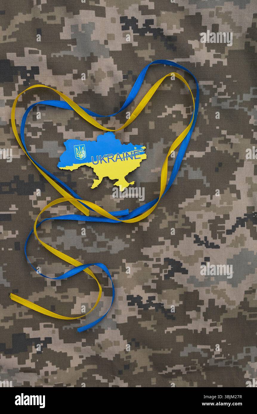 yellow blue cut out shape of country of Ukraine with image of a trident ...