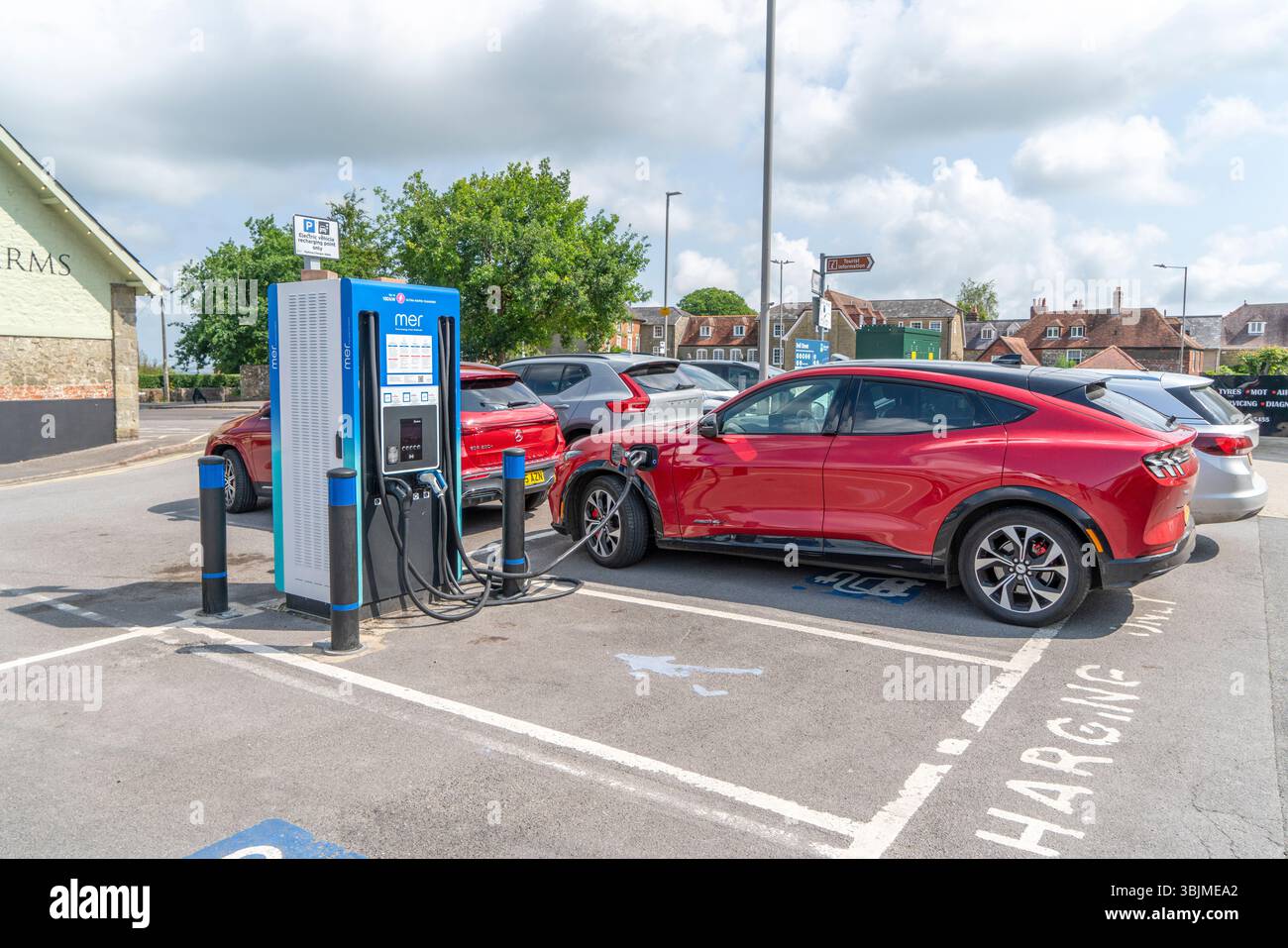 Electric car charging point in public car park Stock Photo - Alamy