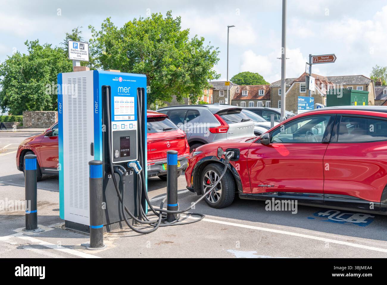 Electric car charging point in public car park Stock Photo - Alamy