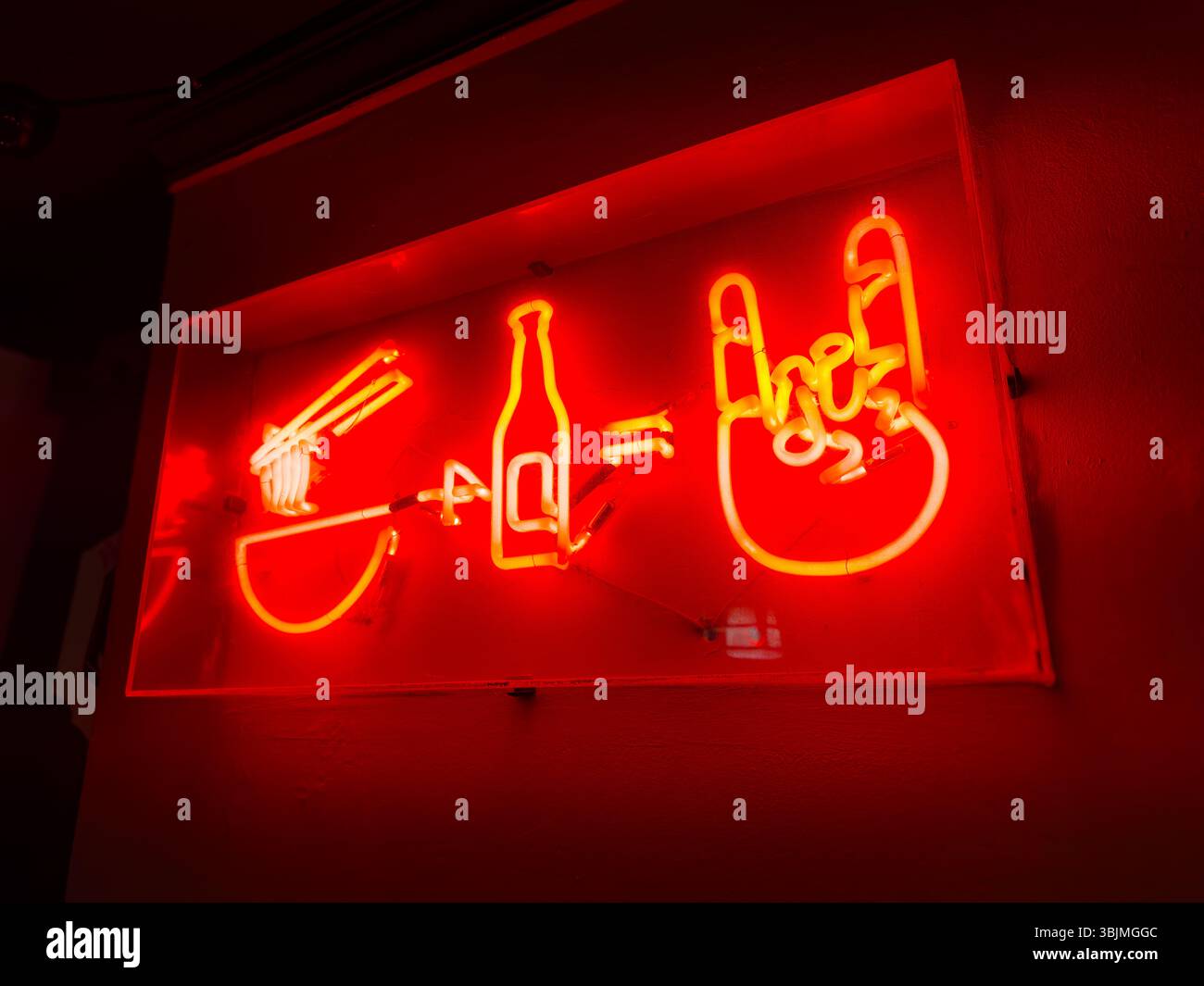Bright red neon sign featuring a bowl of ramen, a beer bottle, and a ...