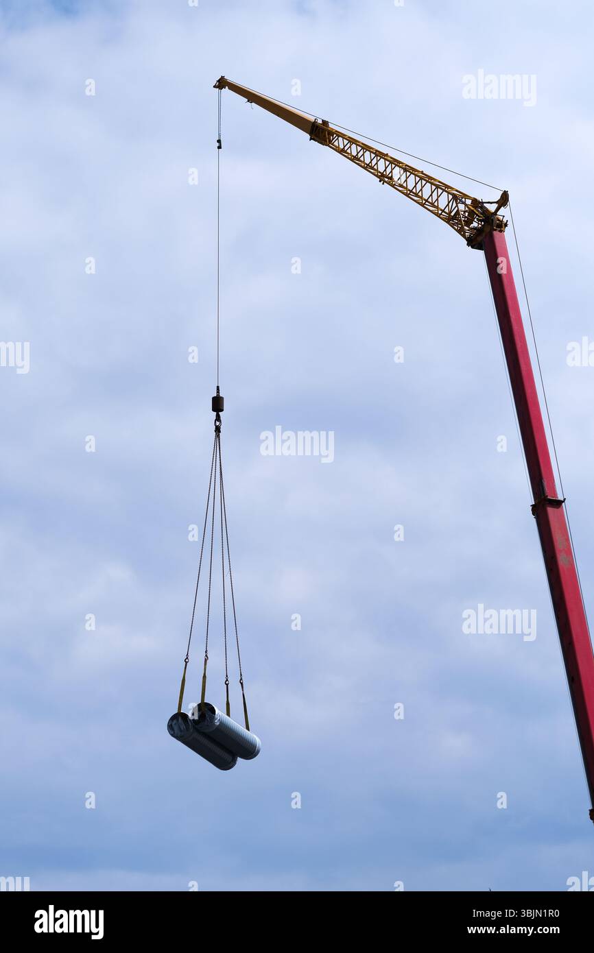 Crane lifting pipes hi-res stock photography and images - Alamy