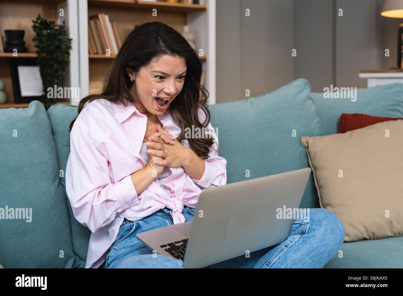 Happy woman at home using laptop for online dating video call. Excited ...