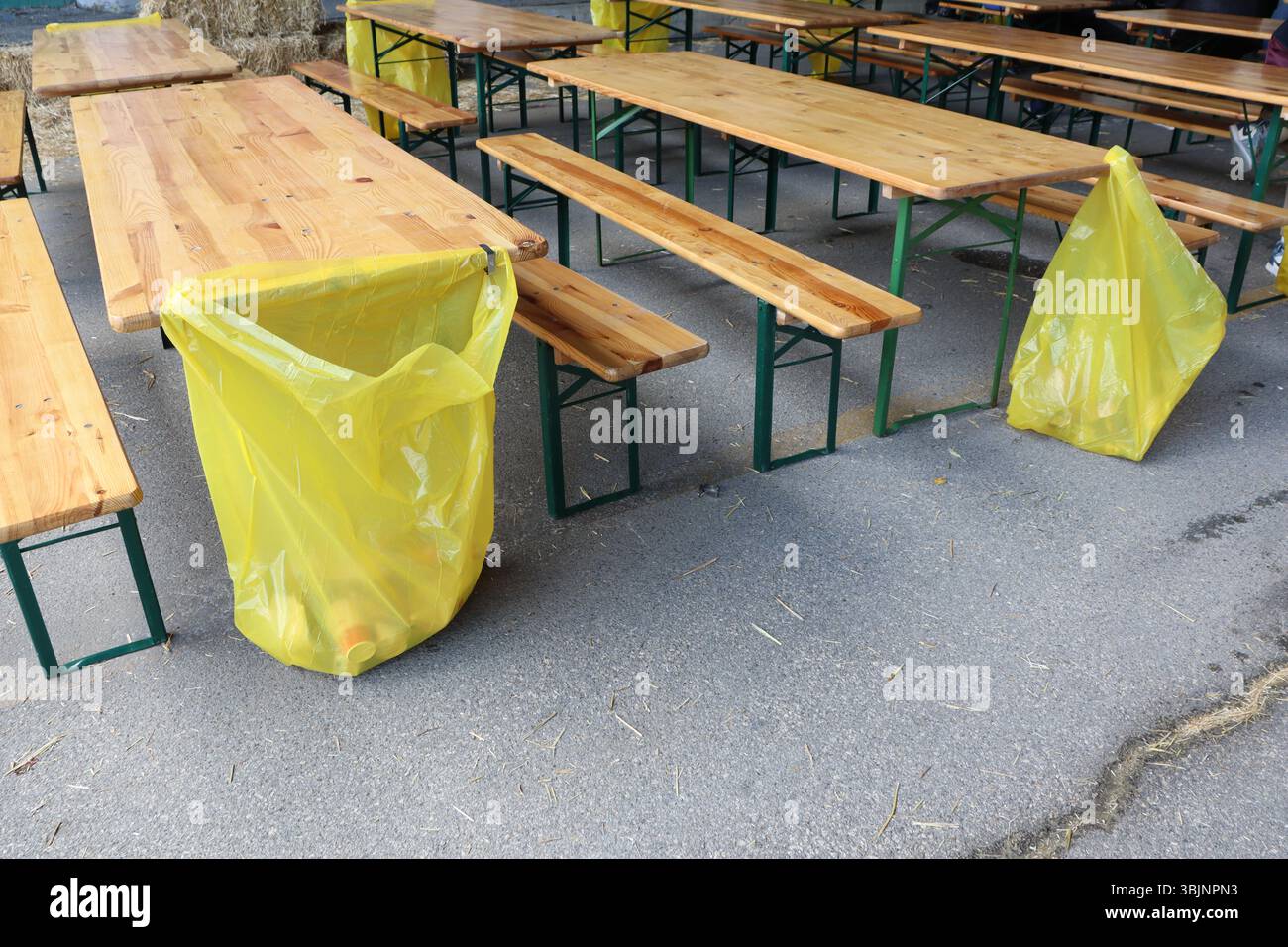 An Outdoor Dining Area that features Yellow Trash Bins for efficient ...