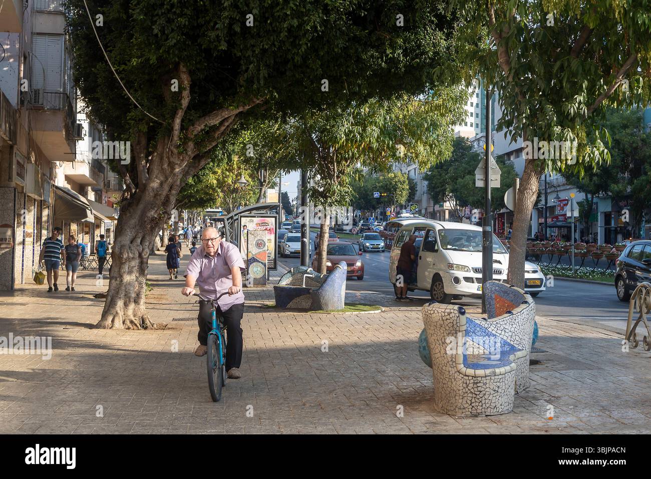 Petah Tikva, Israel, 12 June 2025, Old man Riding Bicycle on a Shaded ...