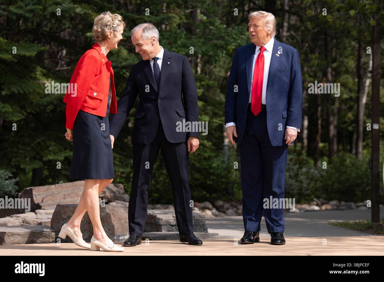 US President Donald Trump is greeted by Diana Fox Carney and the Prime ...
