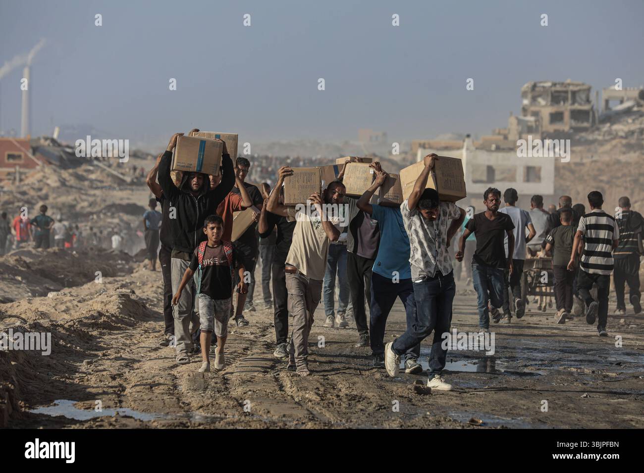 Palestinians carry food parcel, distributed by Gaza Humanitarian Relief ...