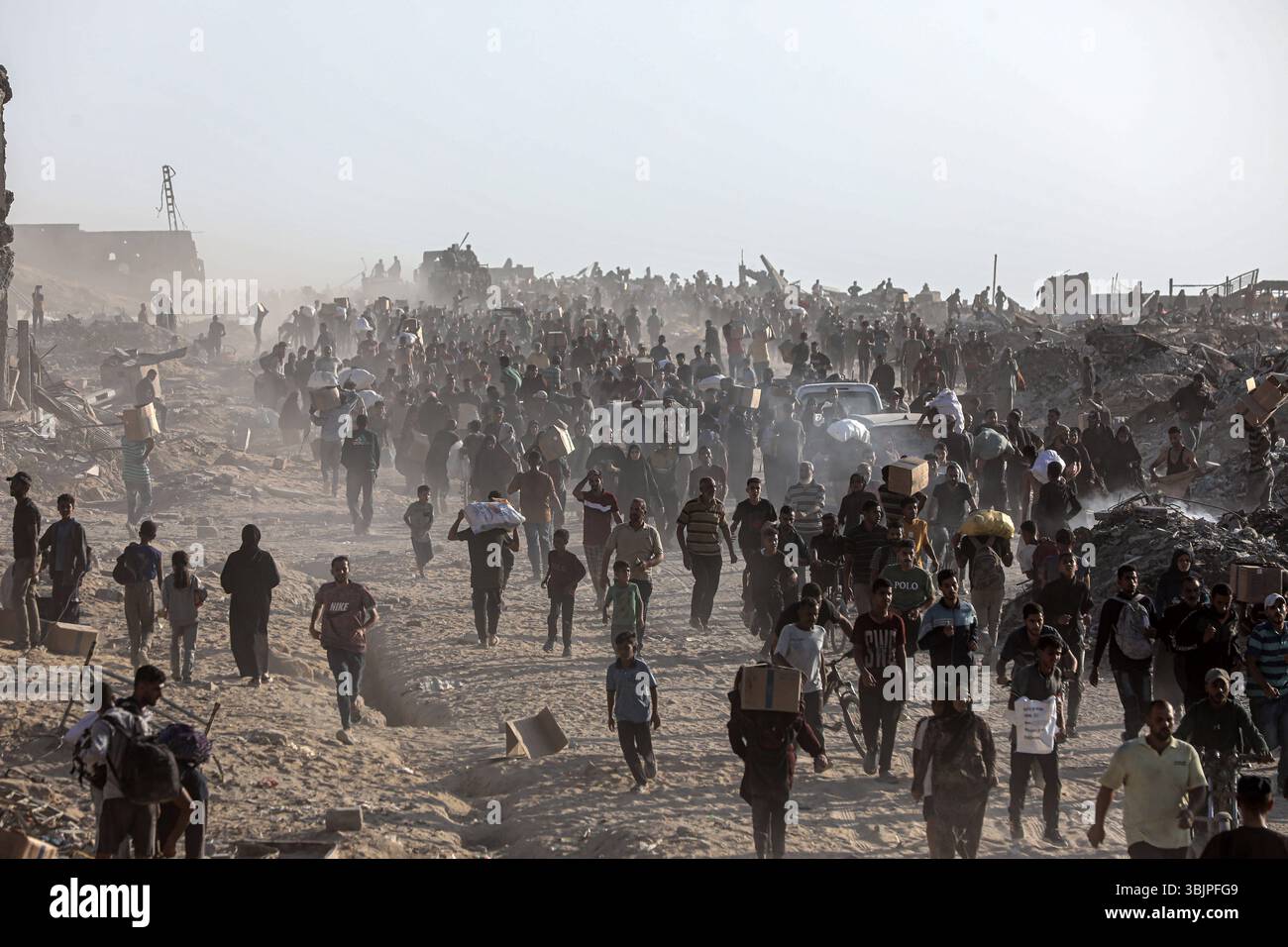 Palestinians carry food parcel, distributed by Gaza Humanitarian Relief ...