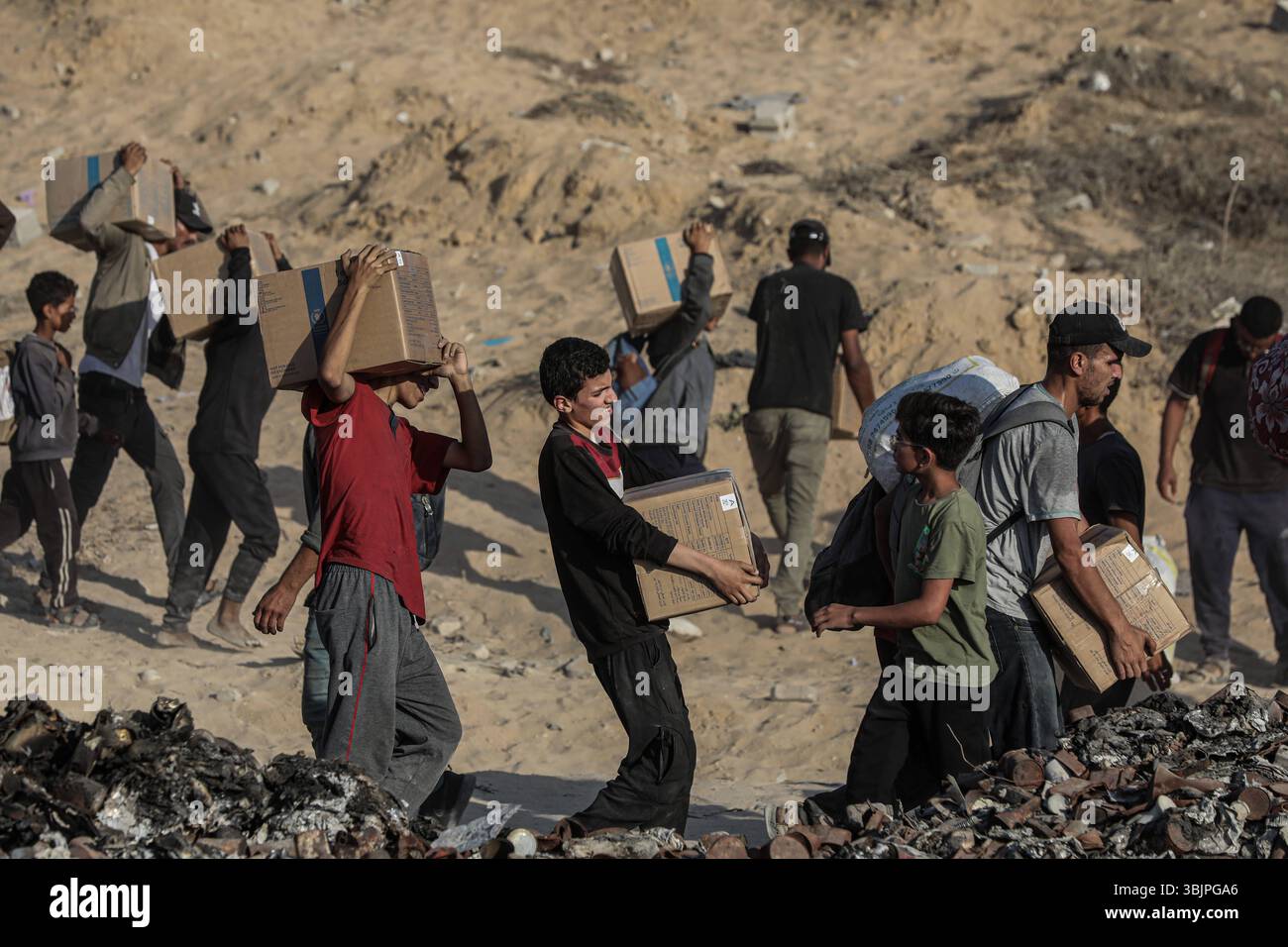 Palestinians carry food parcel, distributed by Gaza Humanitarian Relief ...