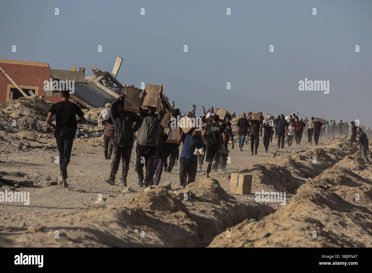 Palestinians carry food parcel, distributed by Gaza Humanitarian Relief ...