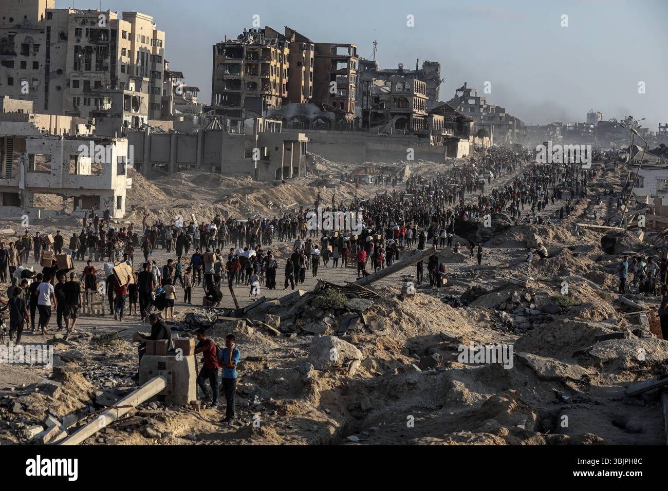 Palestinians carry food parcel, distributed by Gaza Humanitarian Relief ...