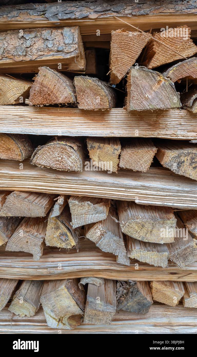 Neatly stacked firewood logs showing rough-cut surfaces and natural ...