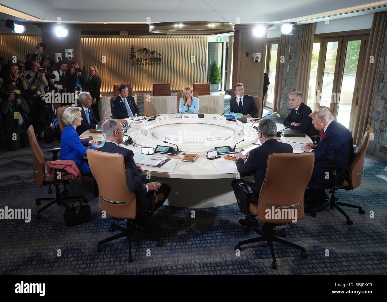 Canadian Prime Minister Mark Carney, back right, speaks during a ...