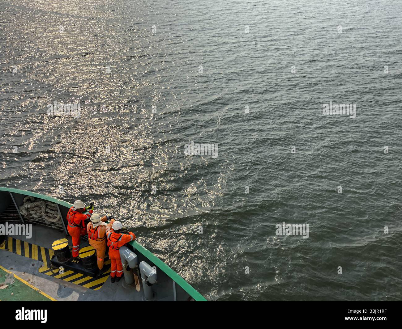 Seafarers are looking forward from the forward station of the offshore ...