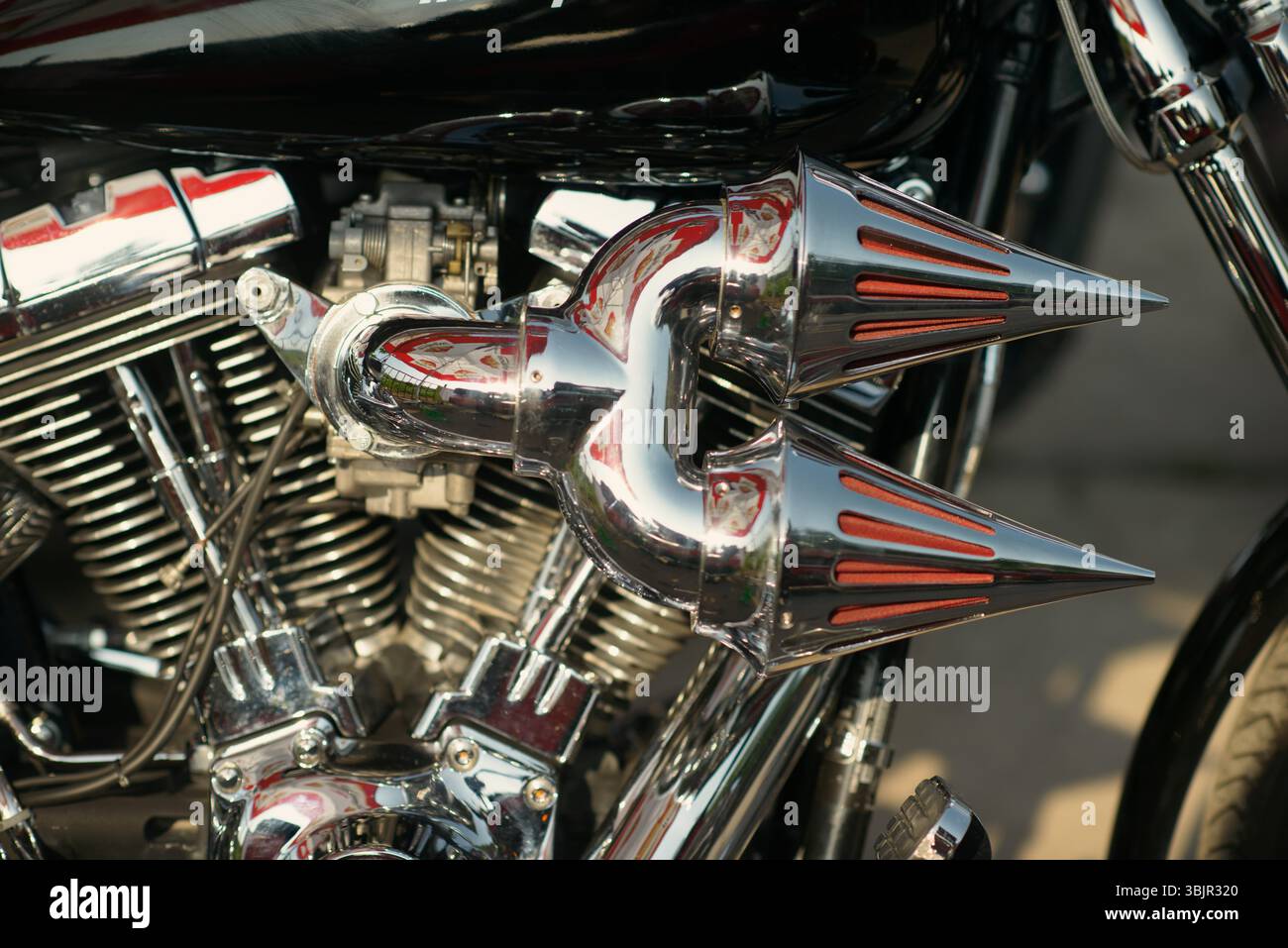 Custom motorcycle V-twin engine displays dual chrome spike air intakes ...