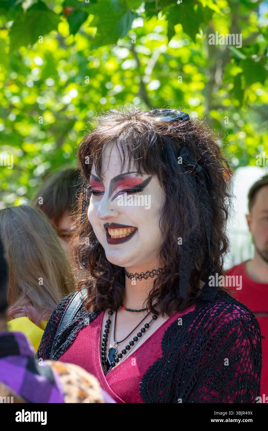Smiling participant with gothic makeup and layered necklaces at the ...