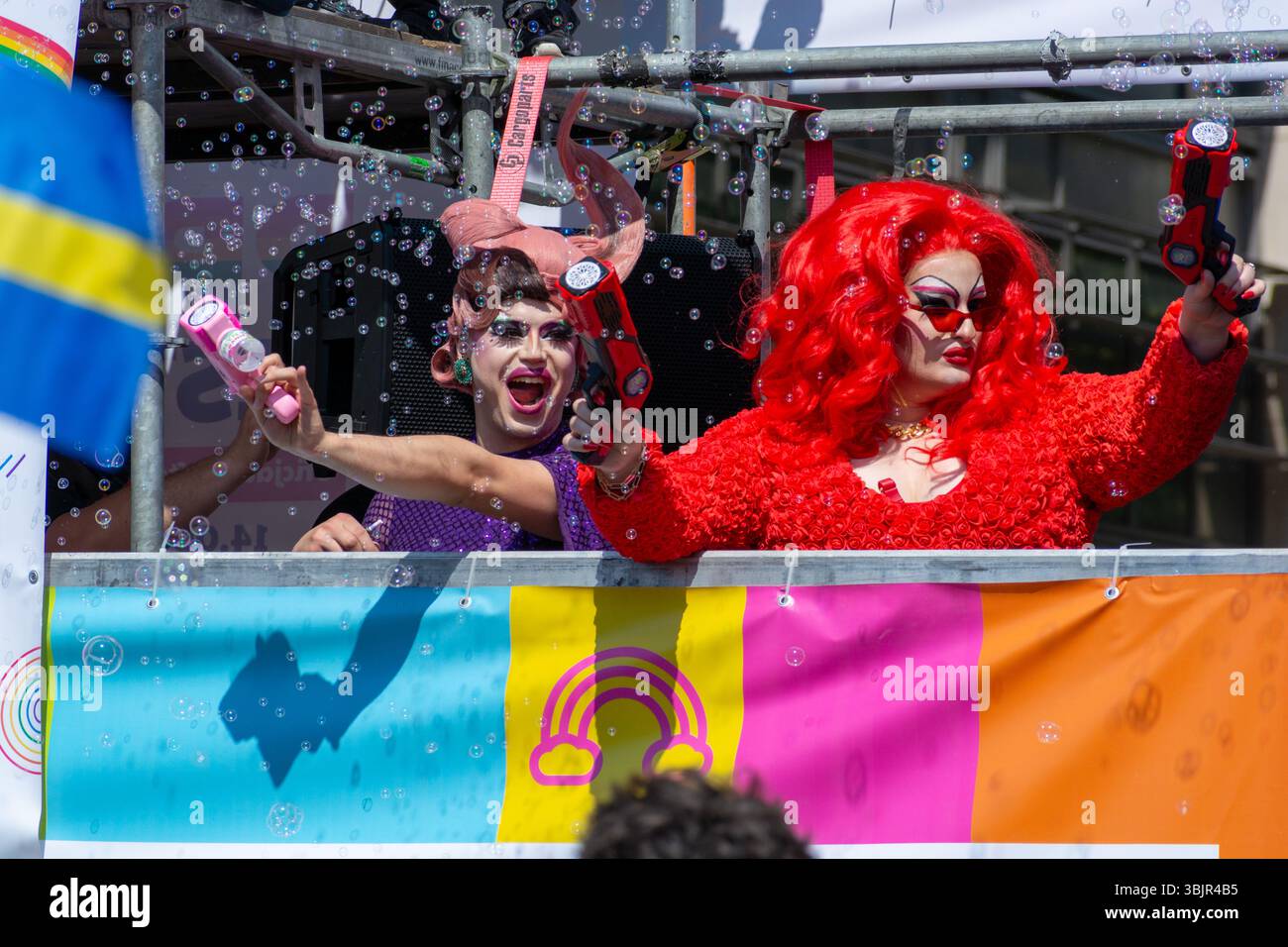 Participants on a rainbow-colored float at the Warsaw Pride parade in ...