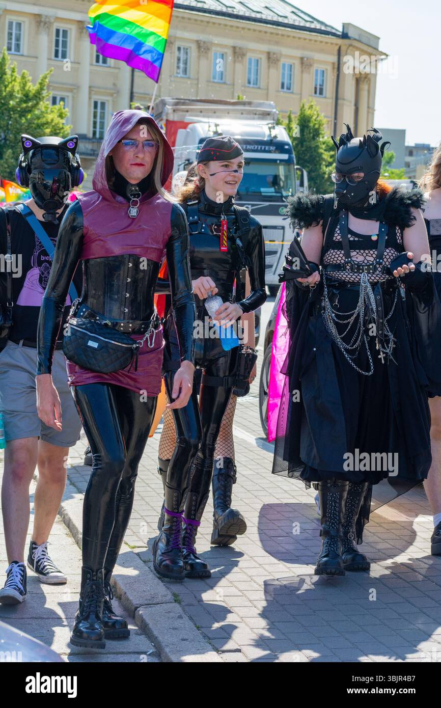 Parade participants wearing leather outfits and animal masks march with ...