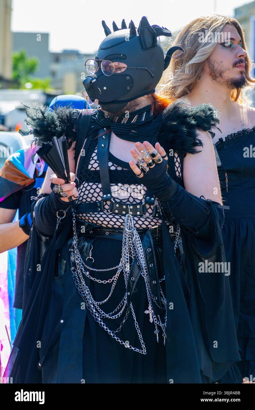 Two costumed participants wearing leather harness, spikes and wings at ...