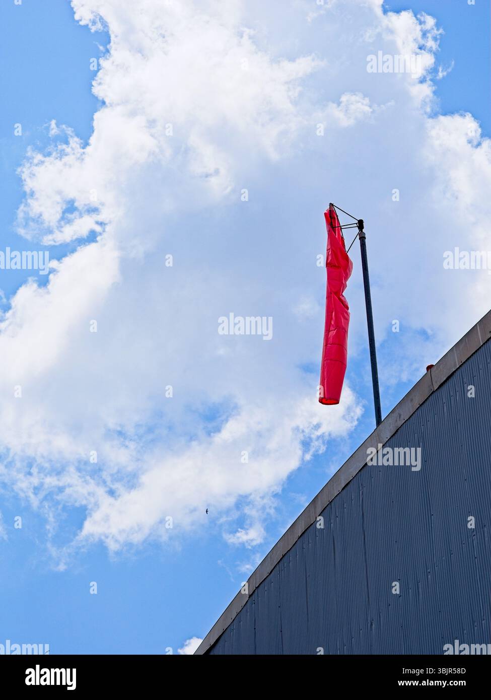 Wind sock under cumulus cloud in calm winds Stock Photo - Alamy