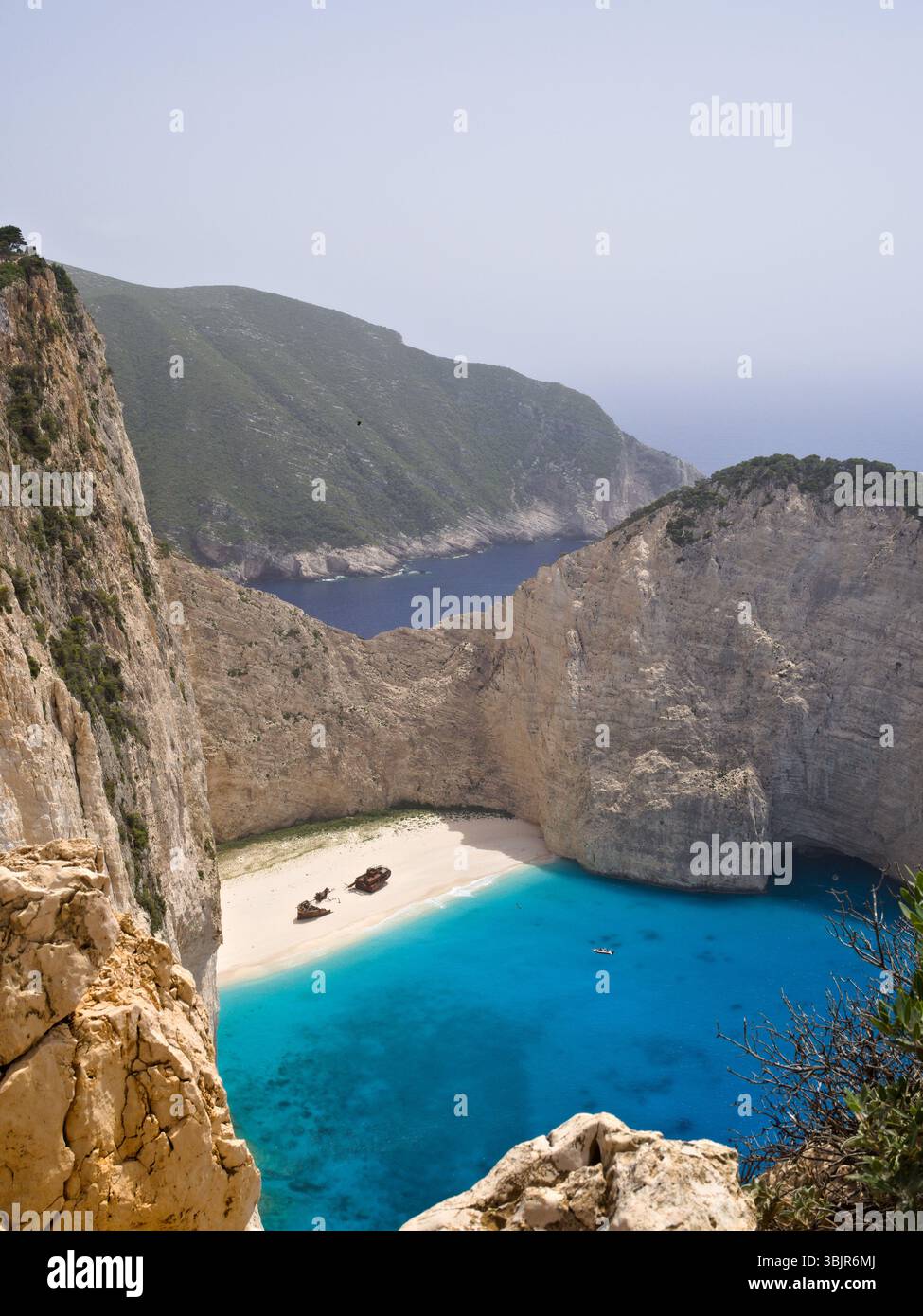 Aerial photo of Navagio Bay with shipwreck, white cliffs, and deep blue ...