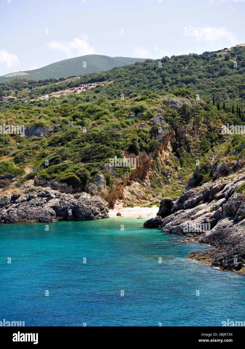 Hidden bay on Zakynthos with turquoise water and steep cliffs covered ...