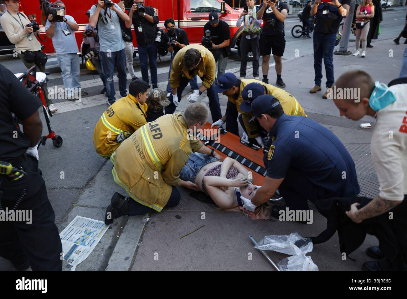 Paramedics carry an injured protester to an ambulance during a protest ...