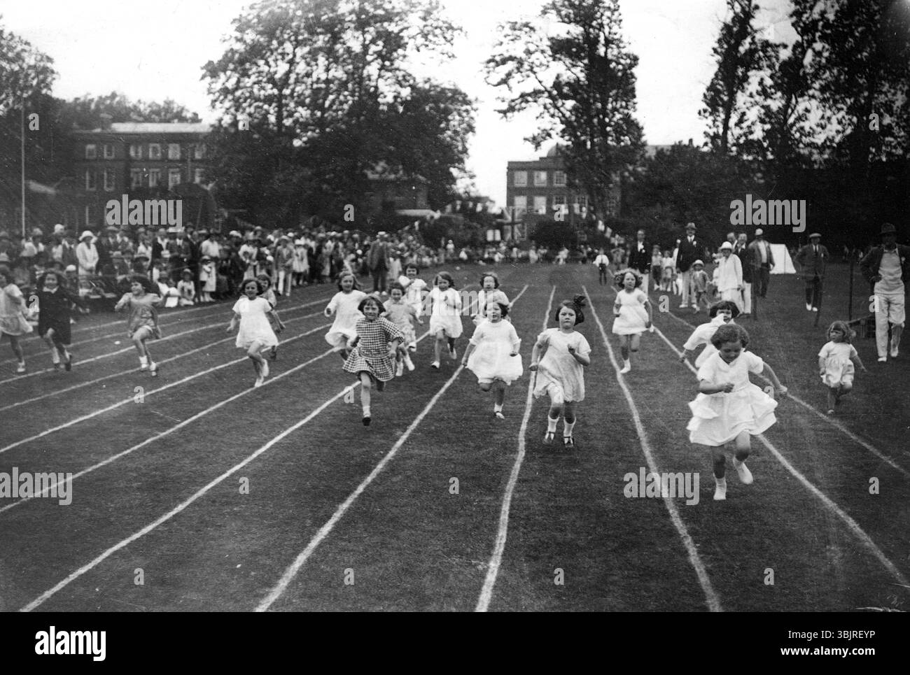 Many girls on race track, 1910, A group of children running on a race ...