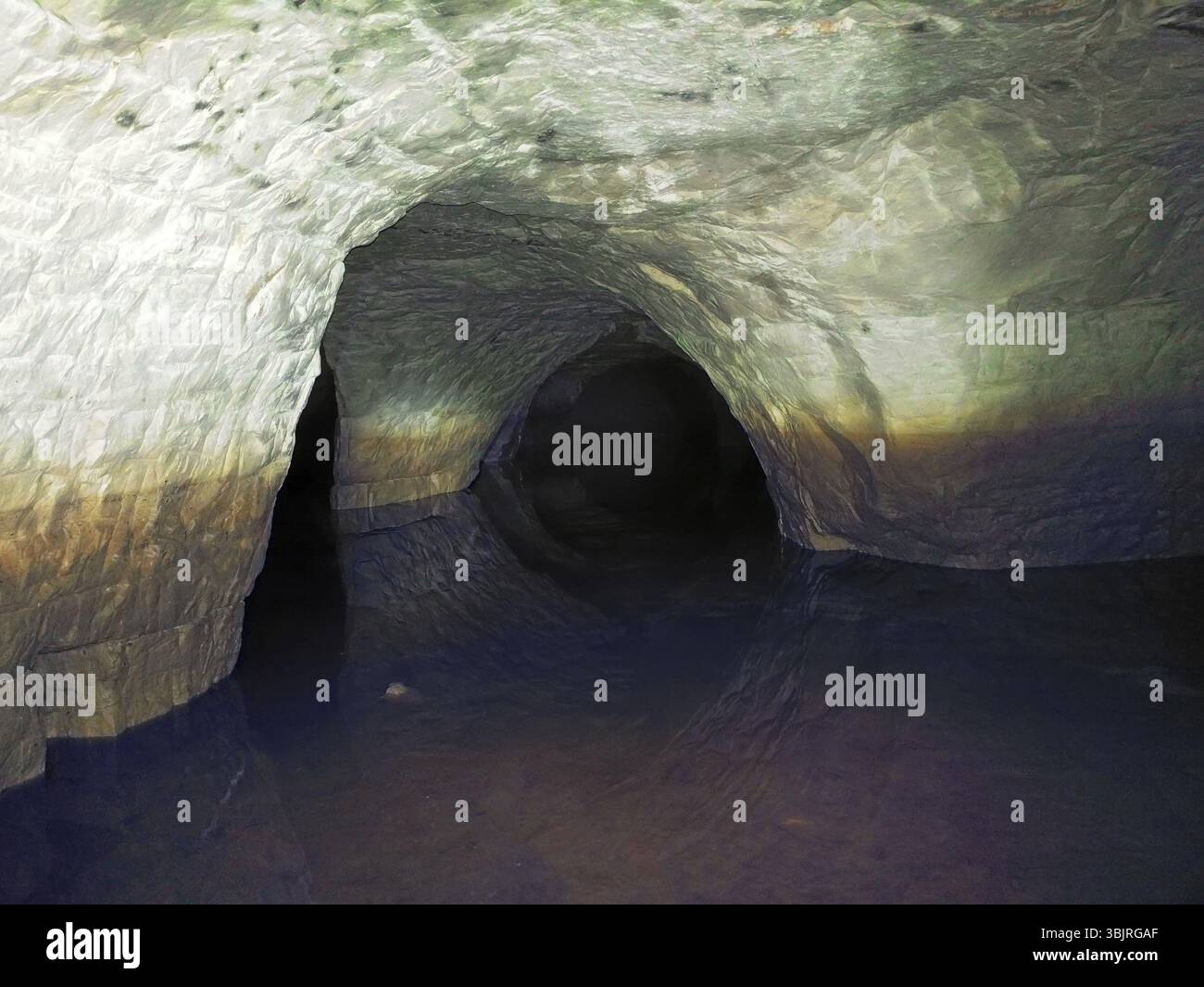 Partially flooded underground caves catacomb. journey underground ...