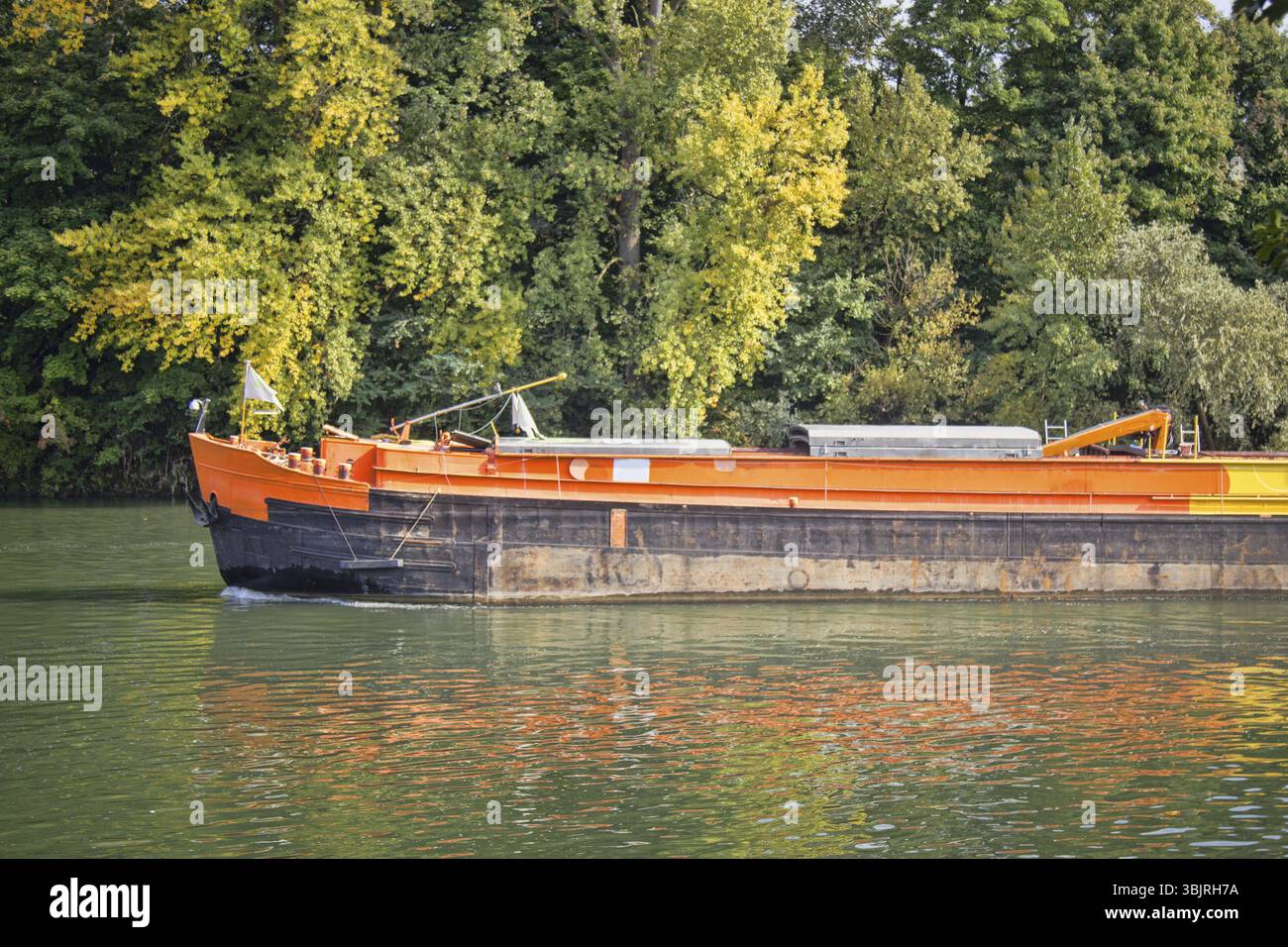 River navigation in France. Barge on Seine. cargo ships floating along ...
