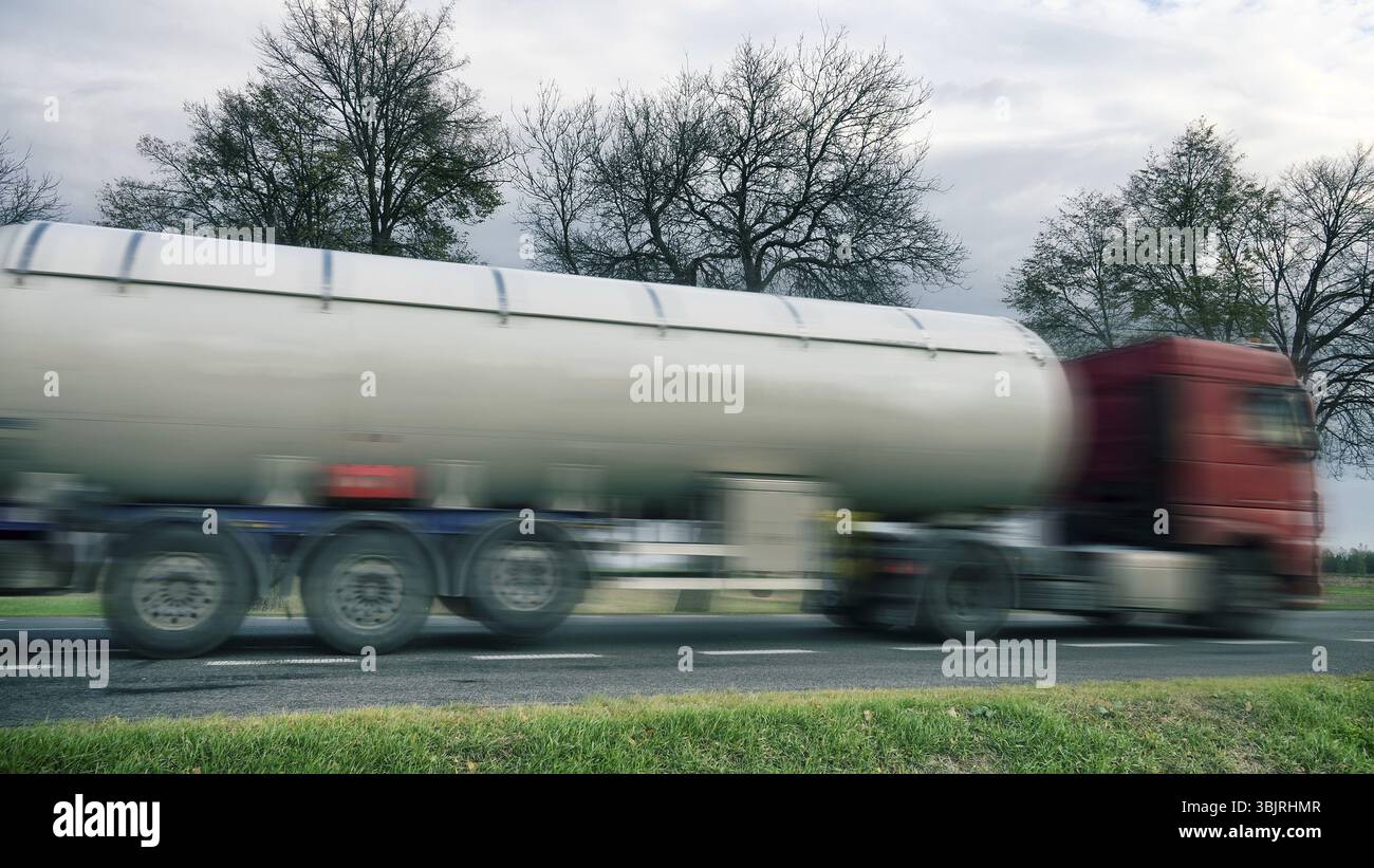 Heavy goods vehicle (tank-car) on highway. Car is blurred to make it ...