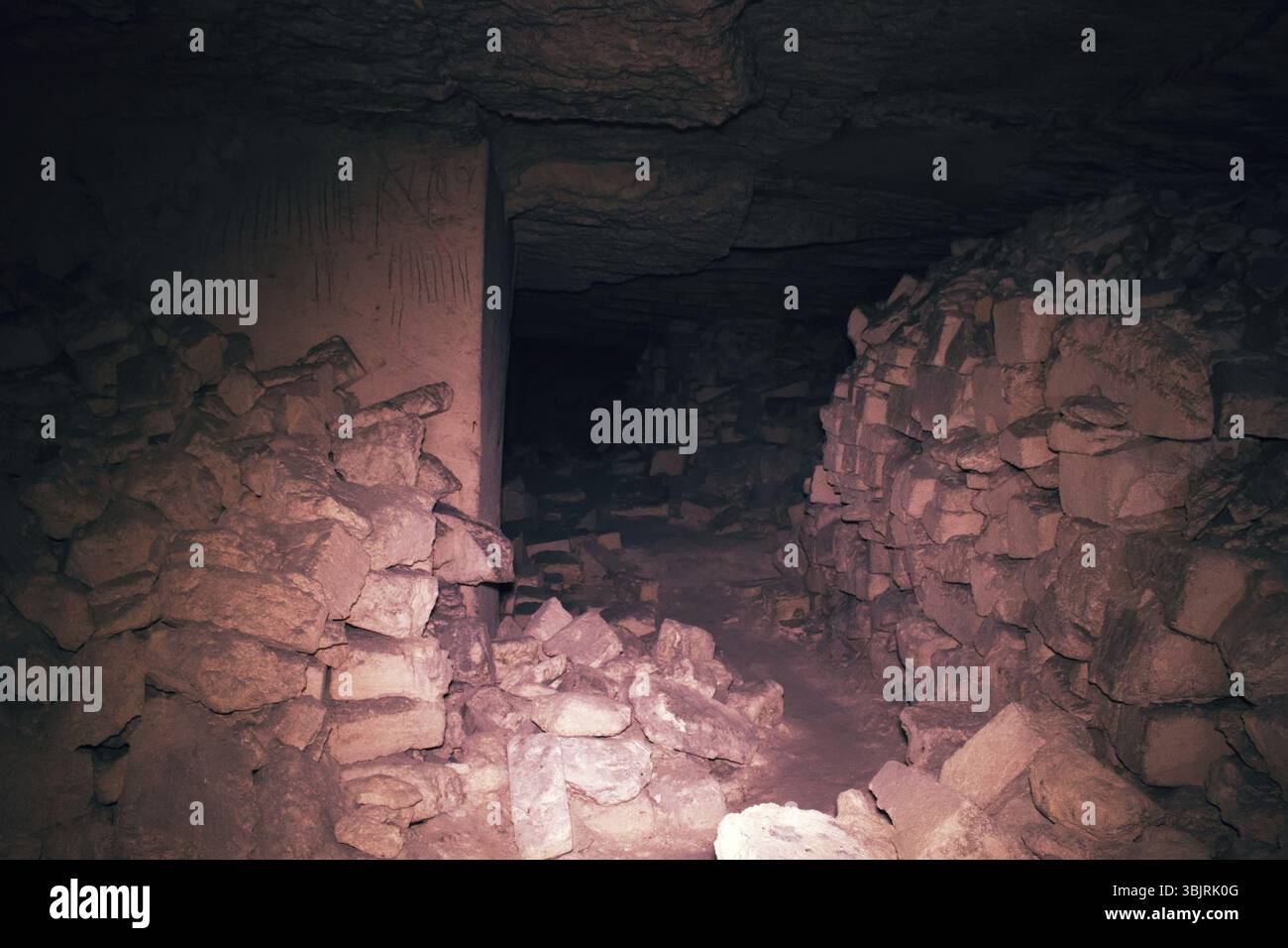 Old underground passage, dungeon, catacombs lined with stones and slabs ...
