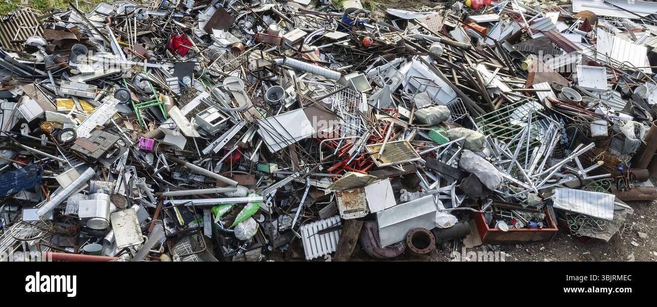 Mountain of scrap metal - predominantly ferrous metals. Village in ...