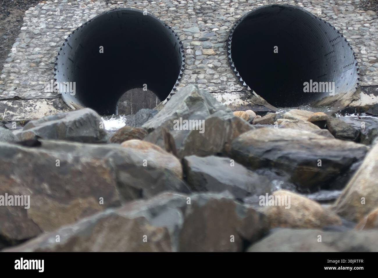 Culvert - drain under road for small river. Big pipe under freeway ...