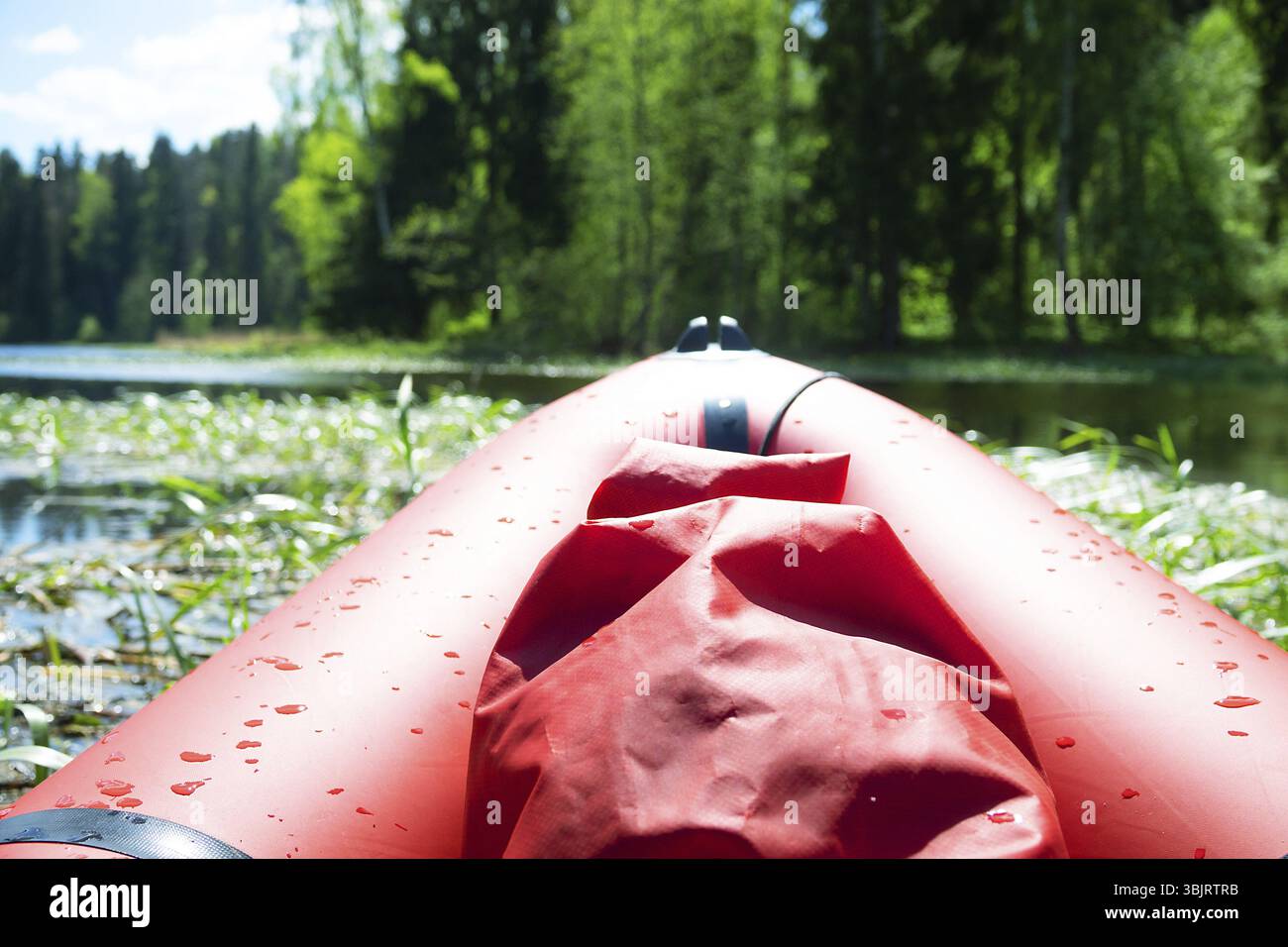 Water-based recreation. Travel on a red inflatable kayak on the small ...