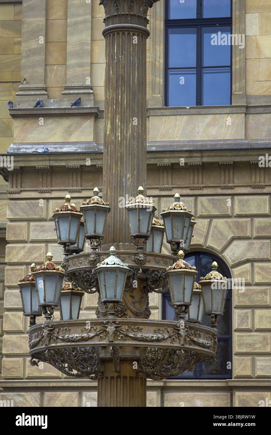 Complex ancient bronze street lamp and the bas-relief of bull heads ...