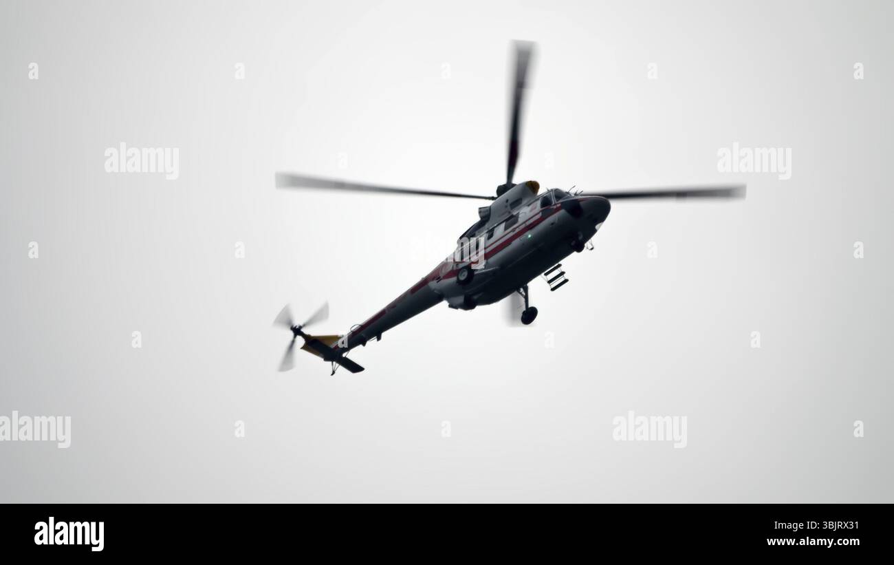 Rescue helicopter with a lowered ramp (safety ladder). Blurred ...