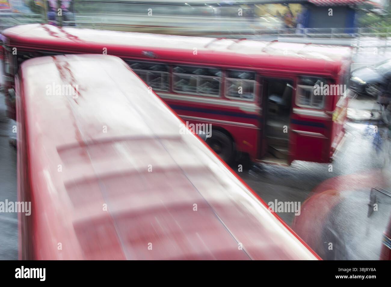 Blur night bus in rainy weather in Southeast Asia. A bunch of buses in ...