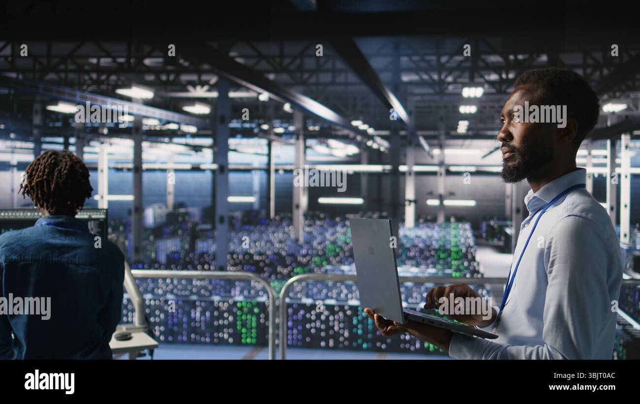 Technicians on data center industrial platform analyzing performance outputs after completing ...