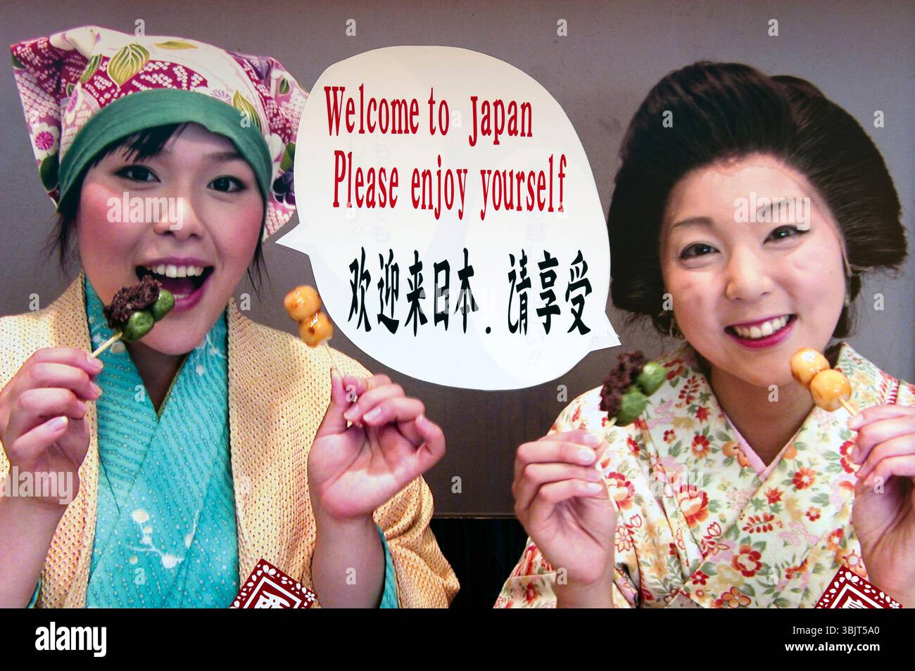 Smiling faces of women inviting visitors to enjoy Japanese dango treats ...