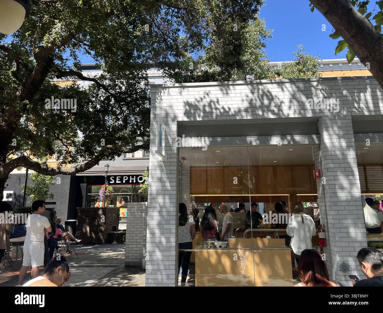 Exterior view of Blue Bottle Coffee with customers standing outside and ...