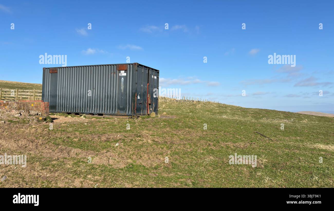 A lone shipping container stands on a Scottish moor, its industrial ...