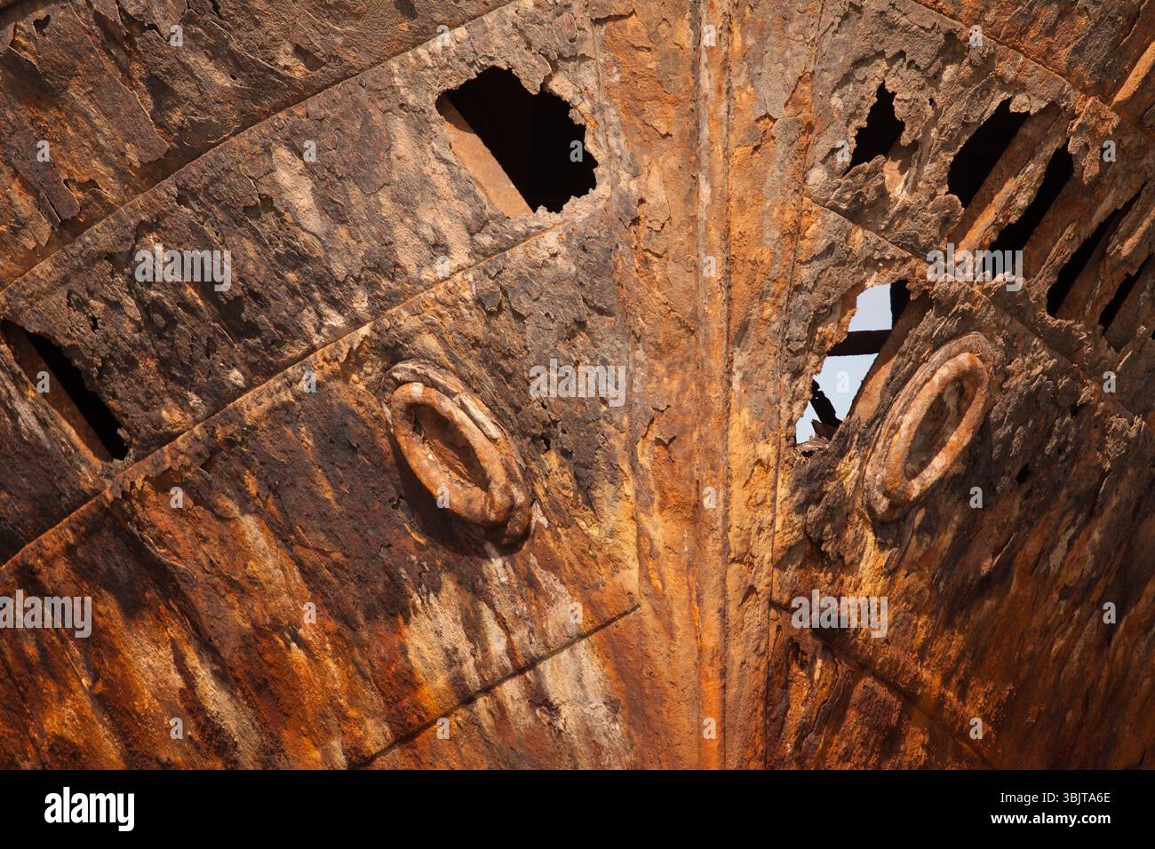 Close-up of a rusted shipwrecked boat on the Moroccan shore, with ...