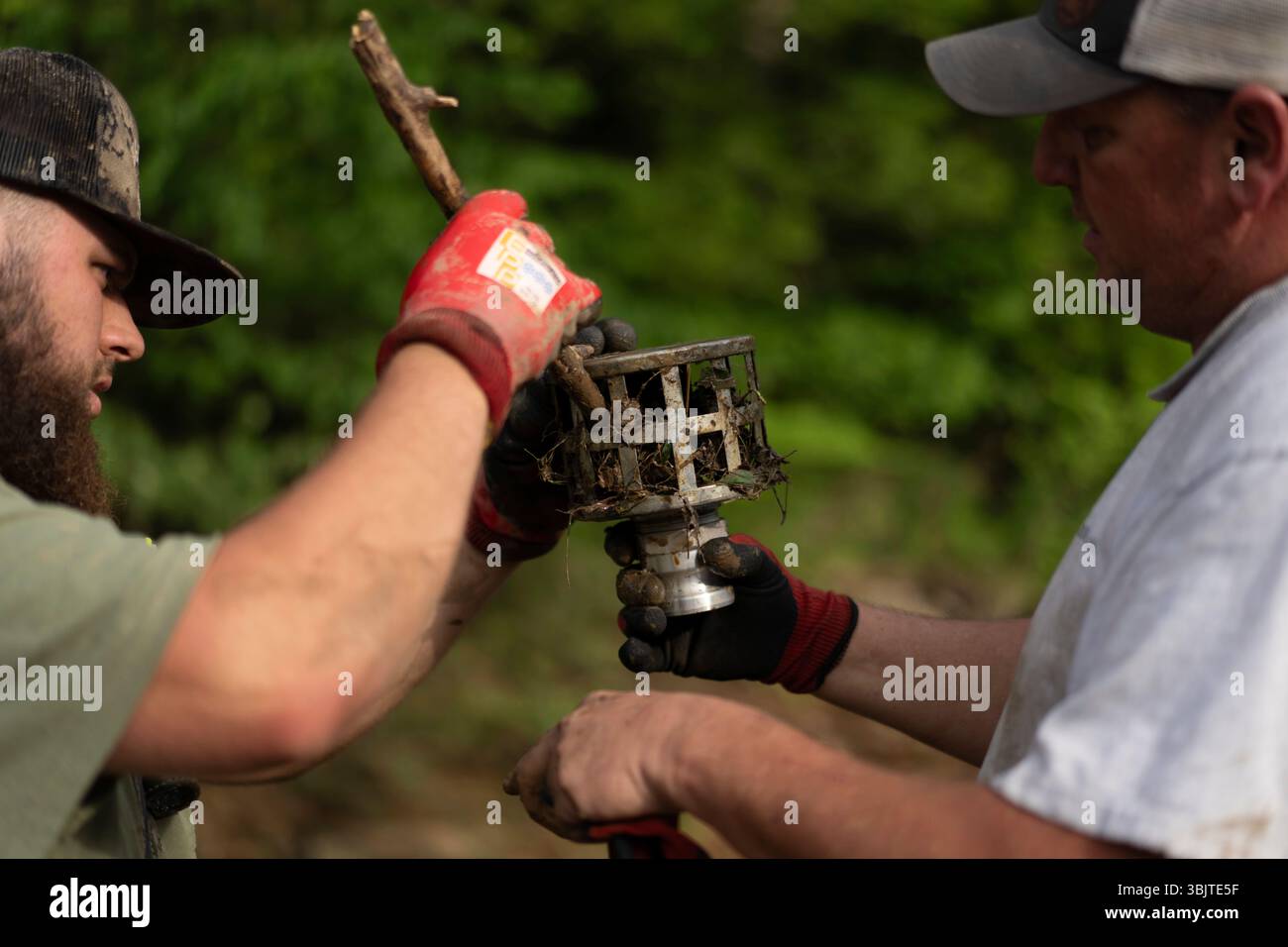 Kyler Gearry, left, and Damian Crowe try to clean the pump filter of ...
