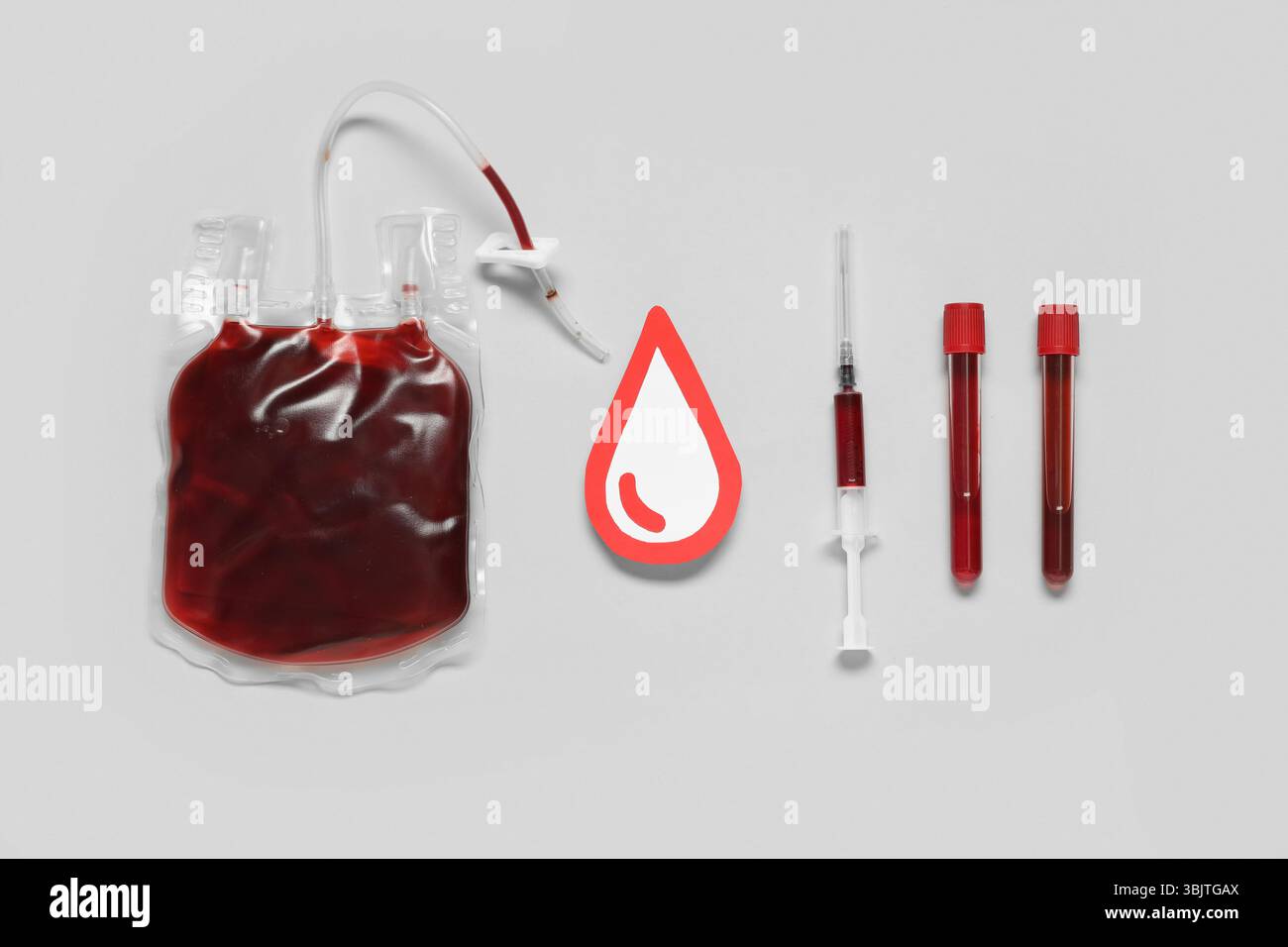 Blood pack for transfusion with test tubes, syringe and red paper drop ...