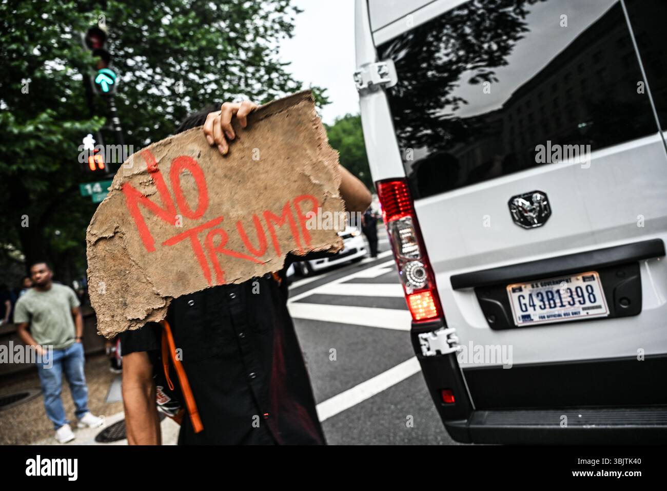 A protester holds a placard during the demonstration. Thousand MAGA ...