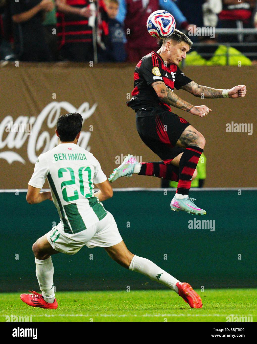 Flamengo's Guillermo Varela, right, heads the ball as Esperance de ...