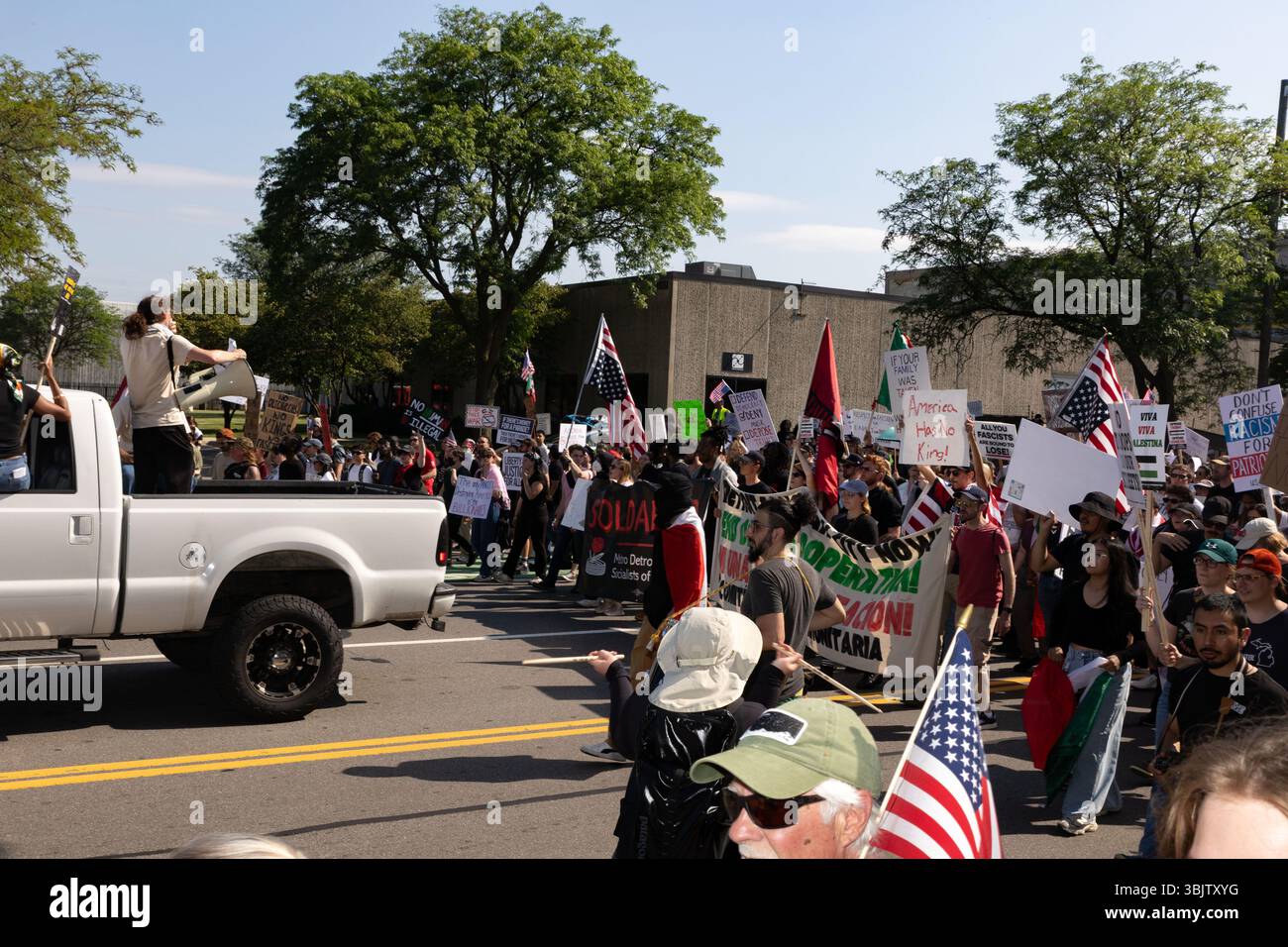 Protesters carry flags, placards and a banner during a march from Clark ...