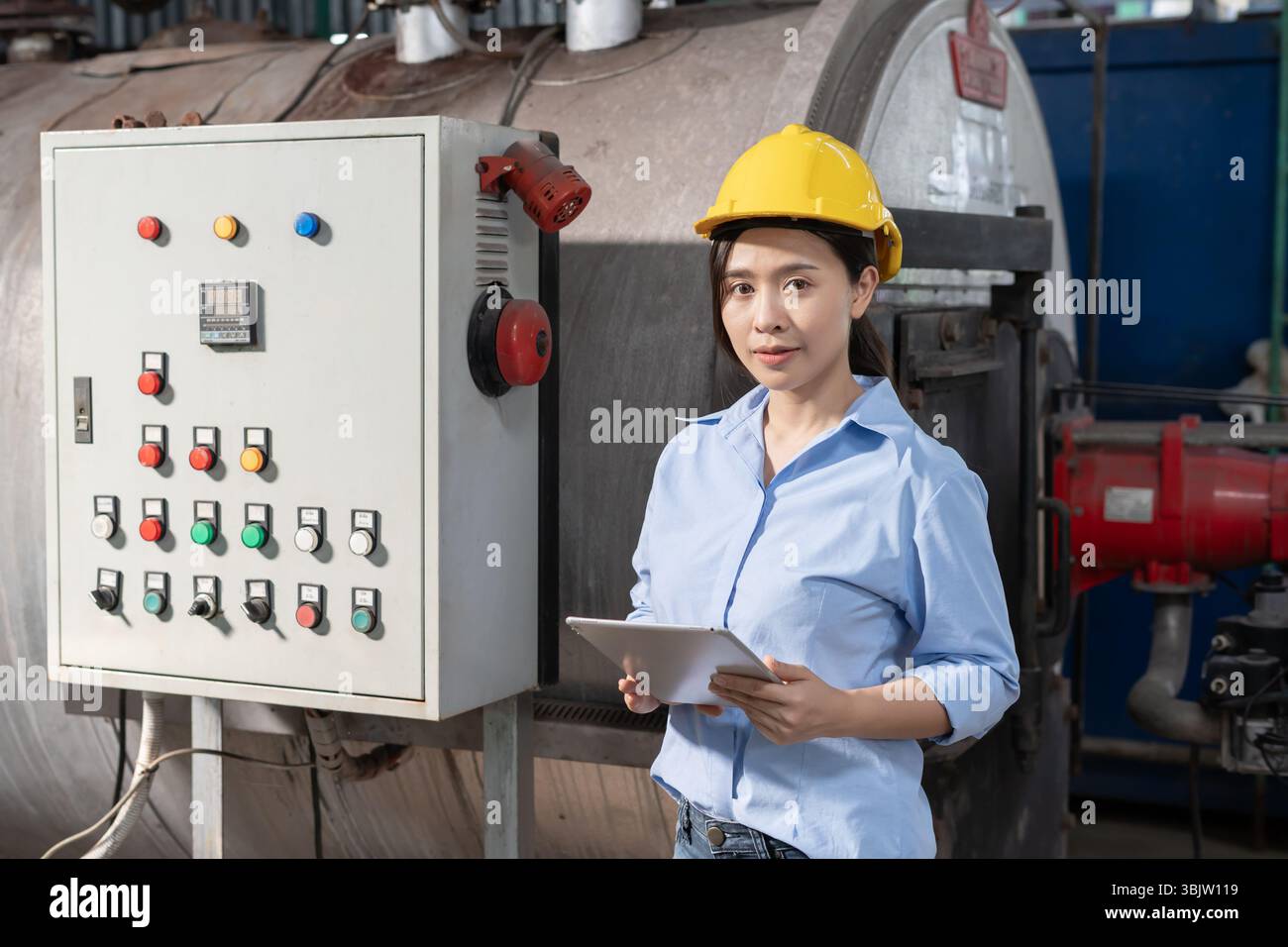portrait Engineers or factory managers wearing safety helmet inspect ...